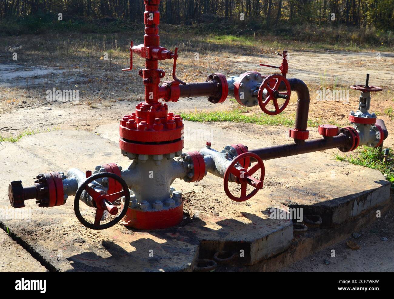 Industrial piping with steel flanges and bolts on oil field. Fuel pipes ...
