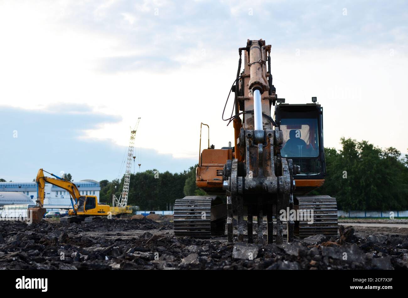 Excavator with hydraulic shears at construction site against the ...