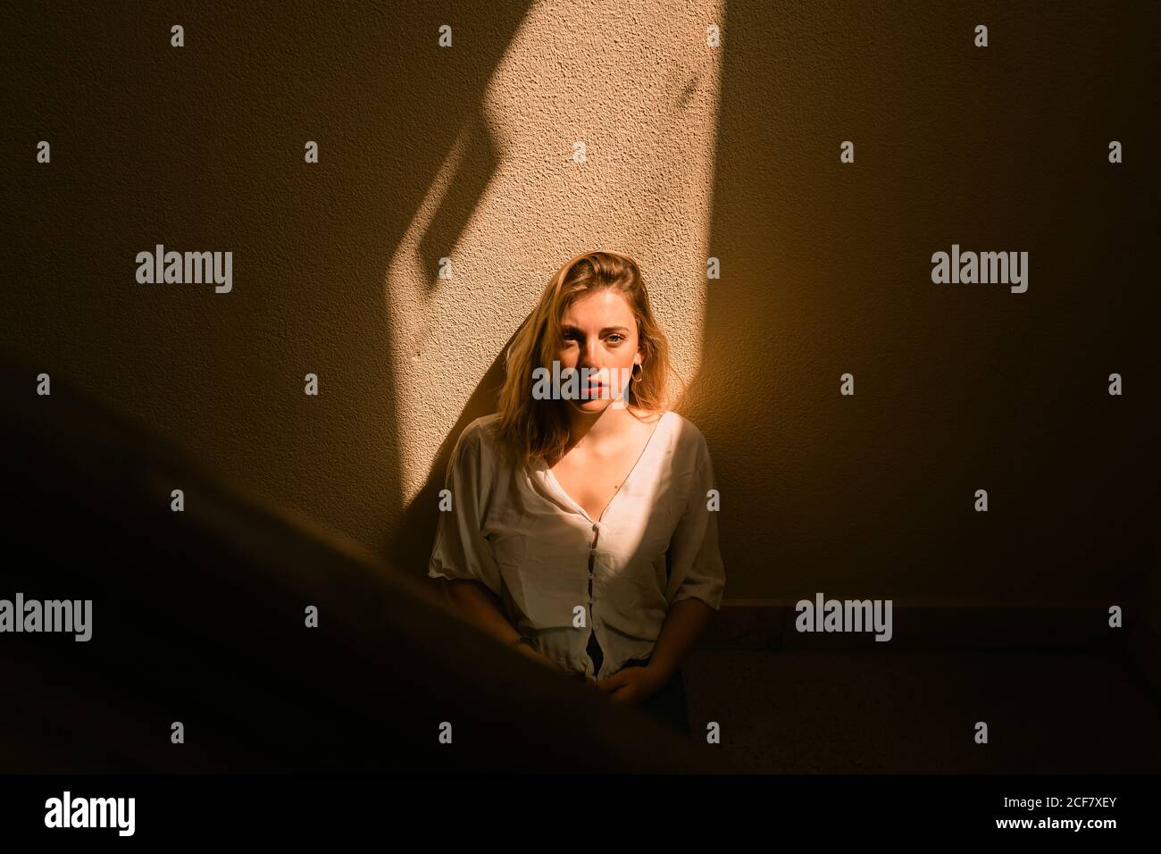Sensitivity young Woman with red lips in casual white jacket sitting in ...