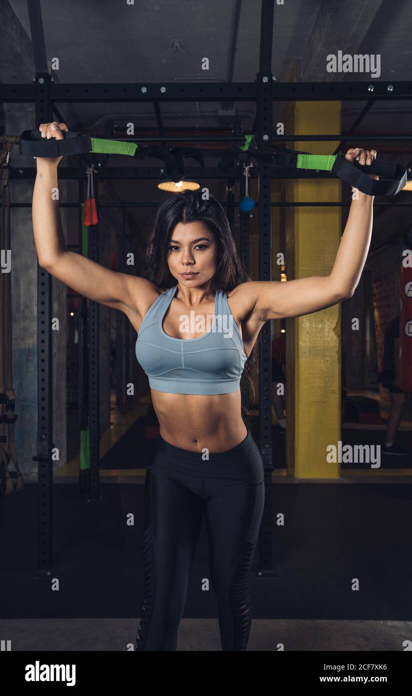 Woman pulling ropes and working out in the gym Stock Photo - Alamy