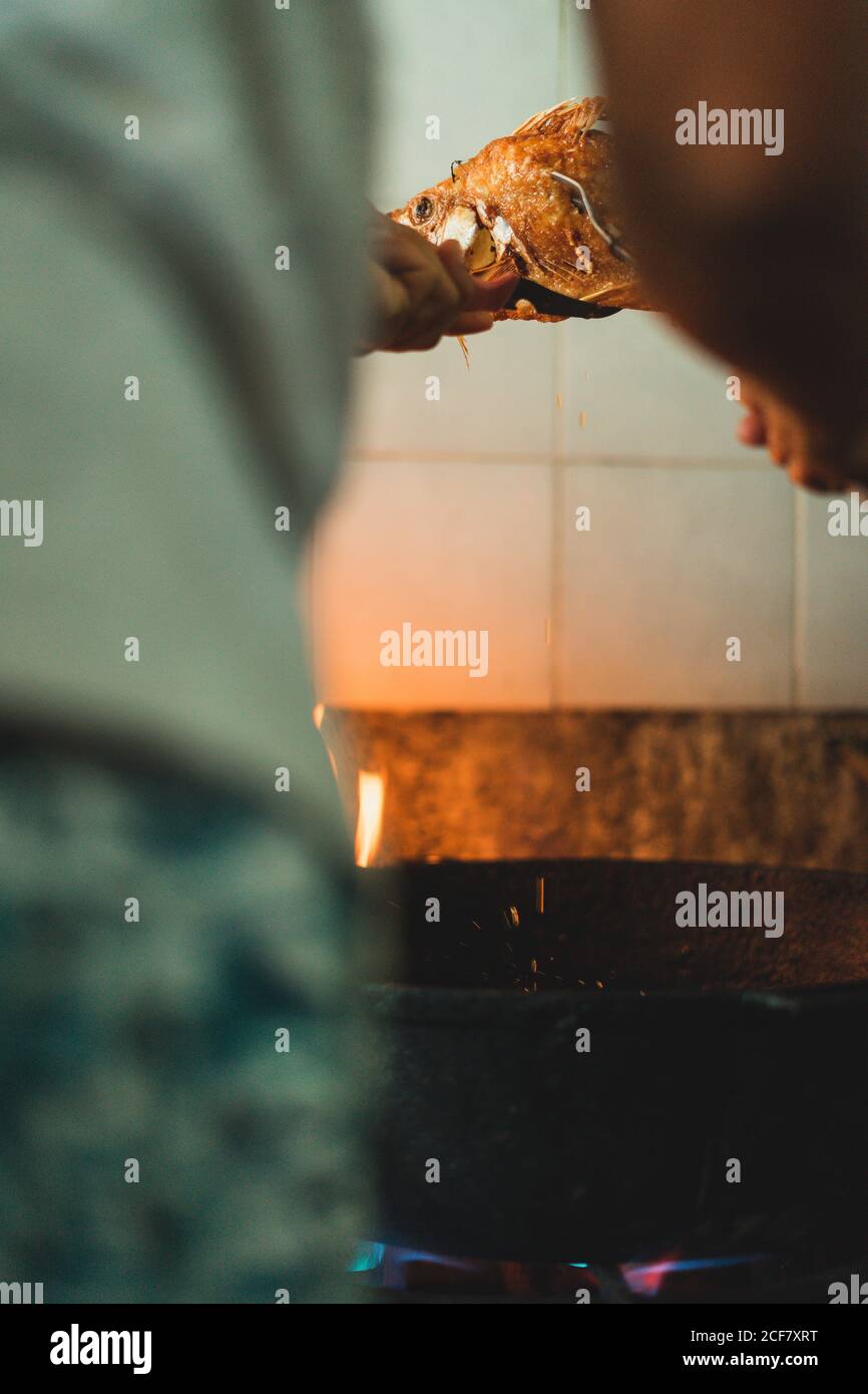 faceless cook preparing fish in kitchen Stock Photo - Alamy