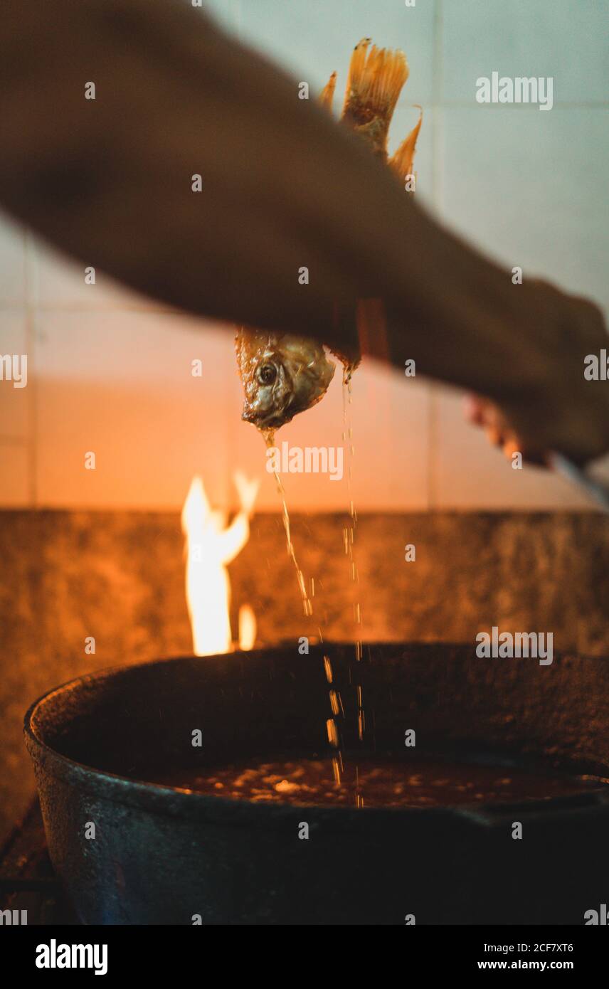 faceless cook preparing fish in kitchen Stock Photo - Alamy