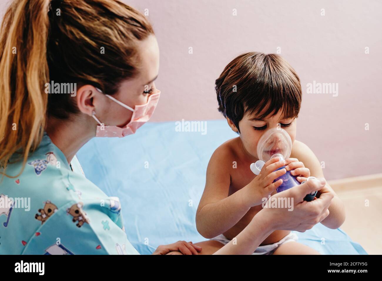 Sick boy getting inhalation treatment in clinic Stock Photo - Alamy