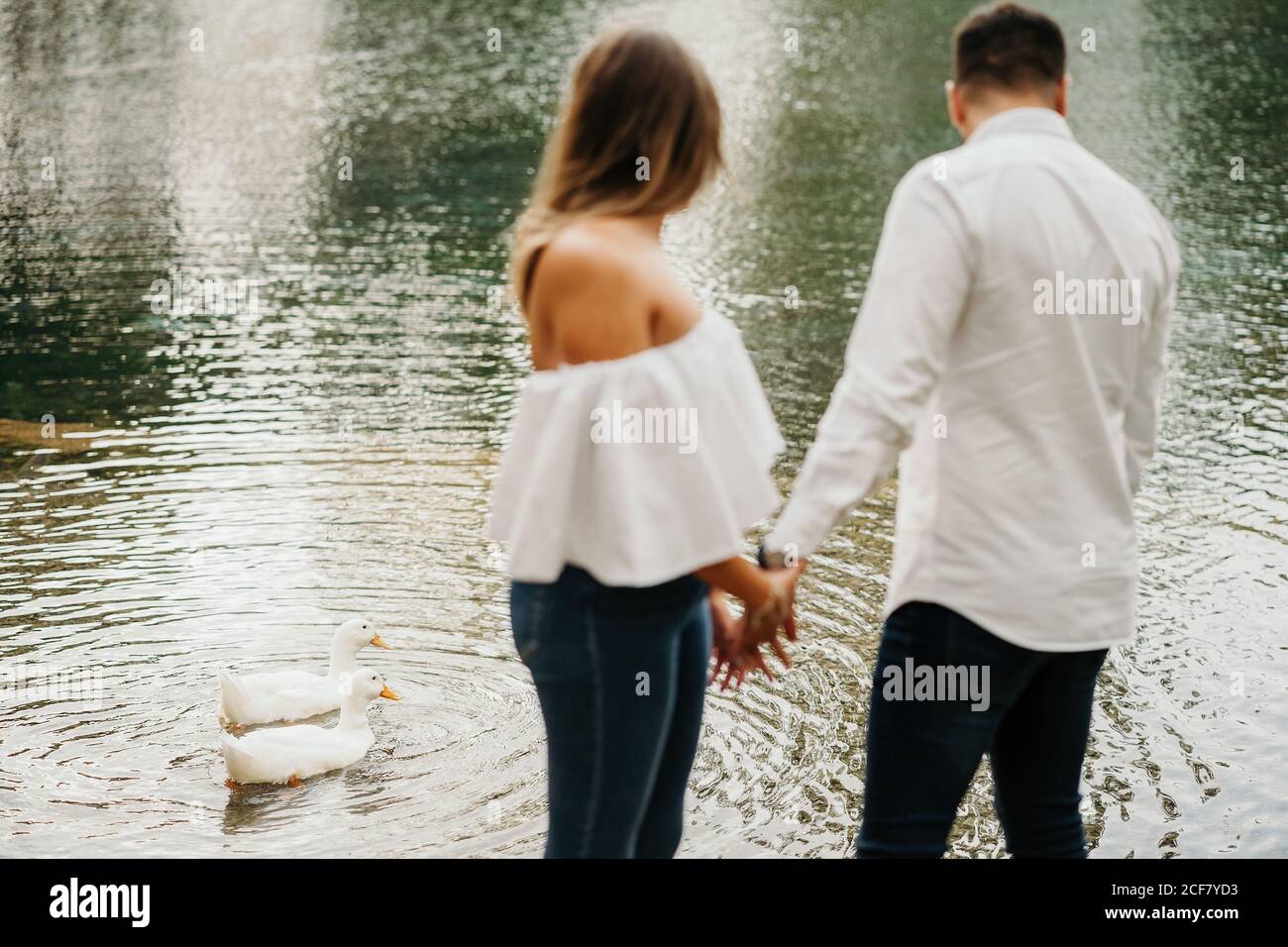 Blurred man and Woman hugging each other while standing near rippling ...