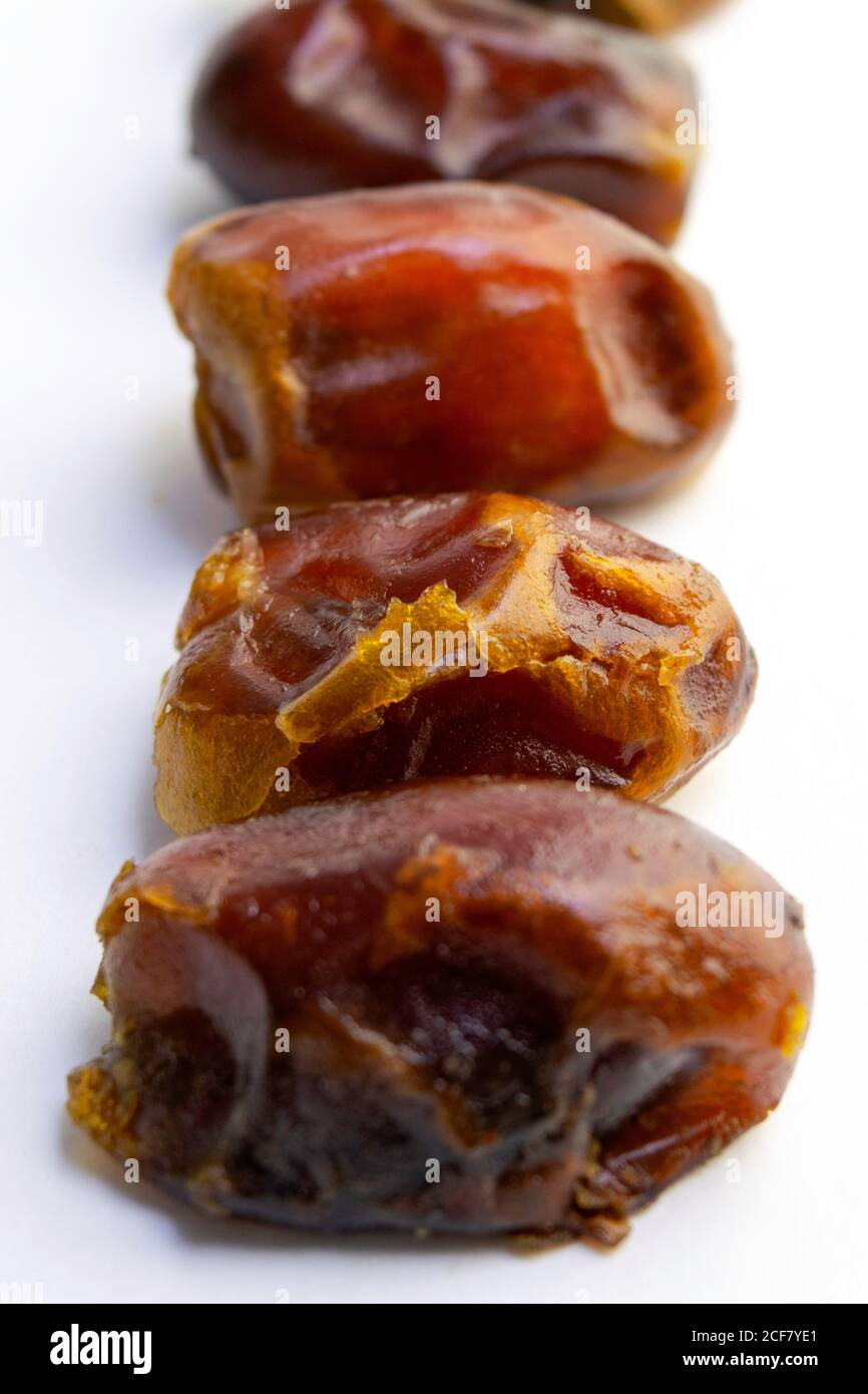 Sweet dry dates laid out in the row, isolated on white background Stock ...