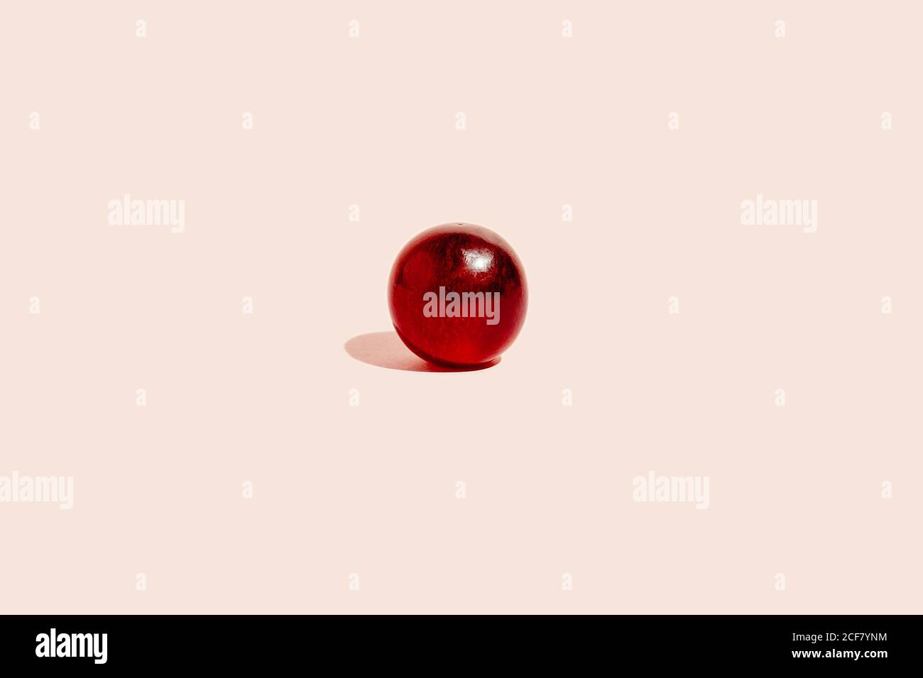 Fresh red single grape arranged on pink surface in studio Stock Photo ...