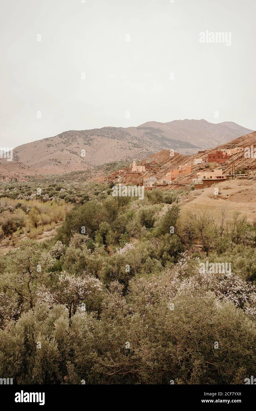 Moroccan landscape with small stone houses located among hills with ...