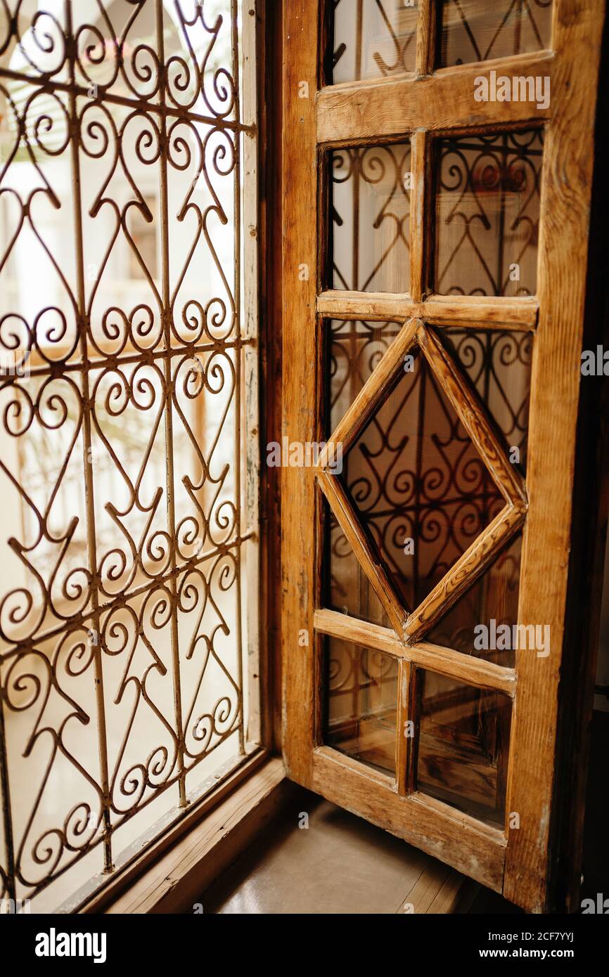 Old vintage window with wooden frames and ornamental grid in ancient ...