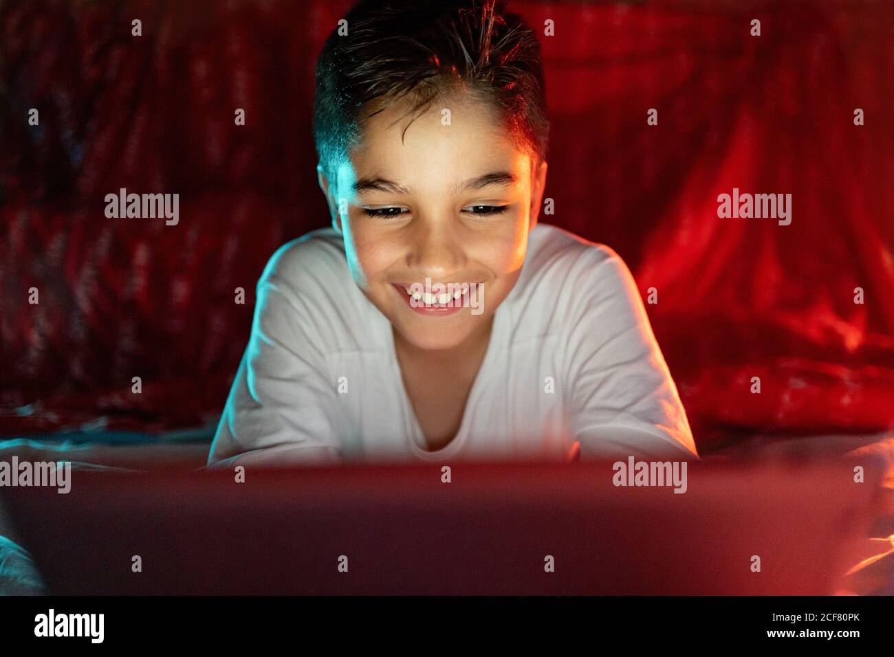 Delighted boy watching cartoon on tablet Stock Photo - Alamy