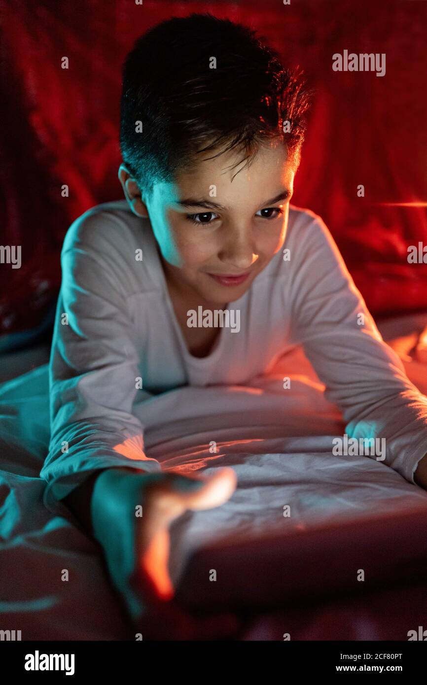 Delighted boy watching cartoon on tablet Stock Photo - Alamy