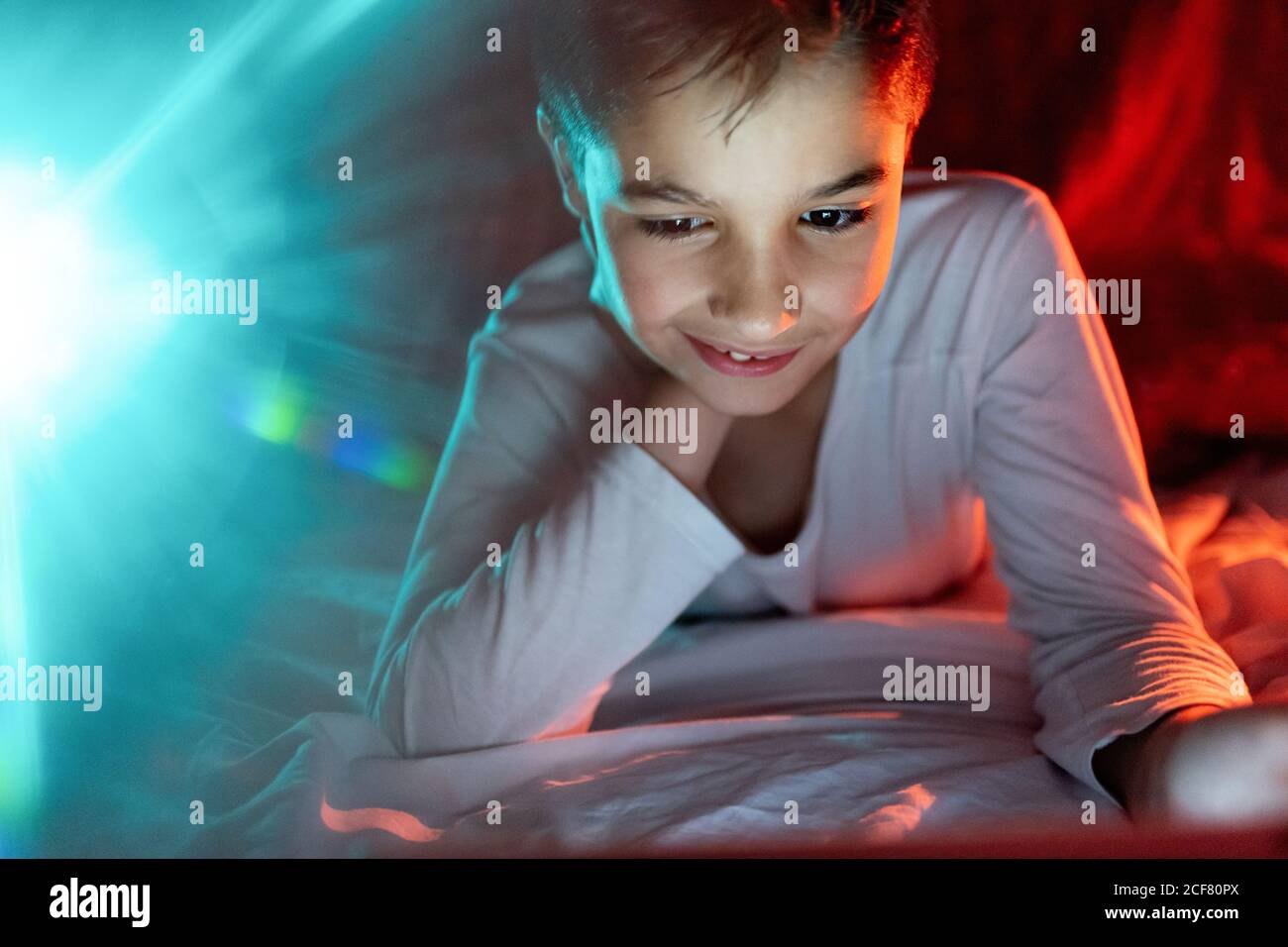 Delighted boy watching cartoon on tablet Stock Photo - Alamy