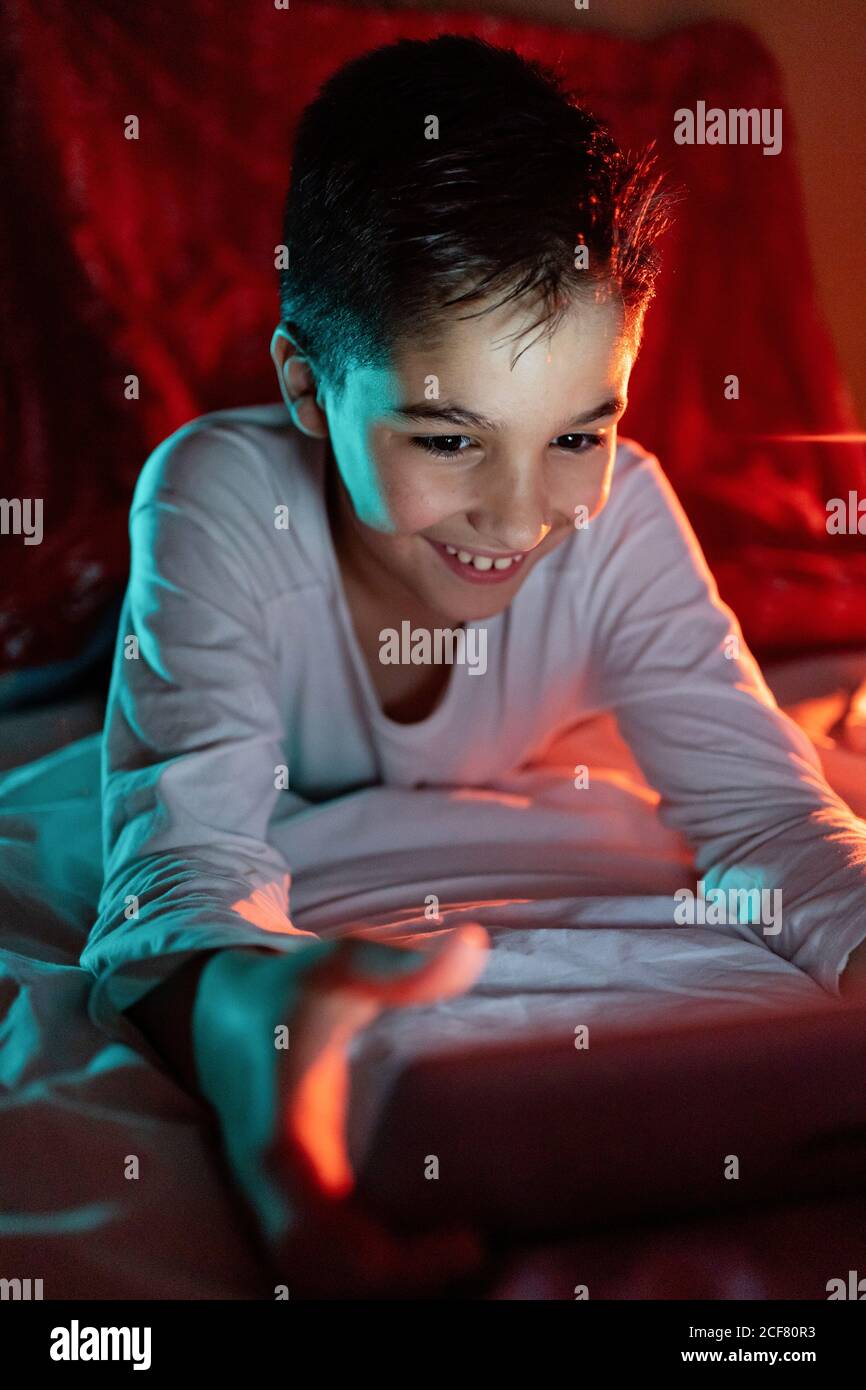 Delighted boy watching cartoon on tablet Stock Photo - Alamy
