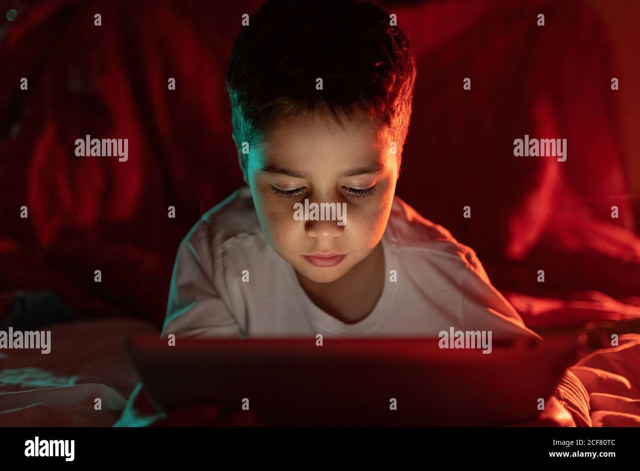 Delighted boy watching cartoon on tablet Stock Photo - Alamy