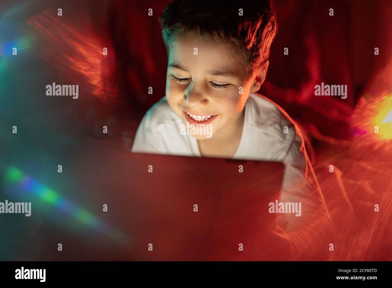 Delighted boy watching cartoon on tablet Stock Photo - Alamy