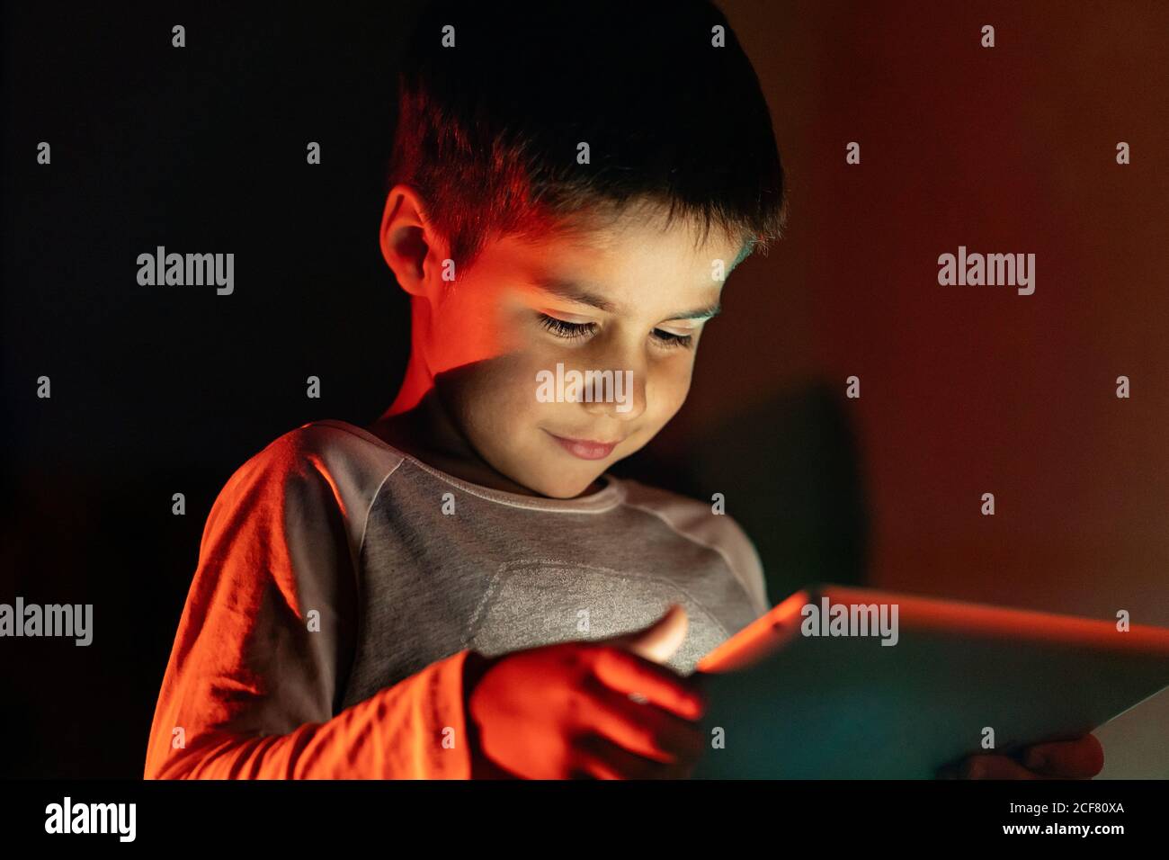 Delighted boy watching cartoon on tablet Stock Photo - Alamy
