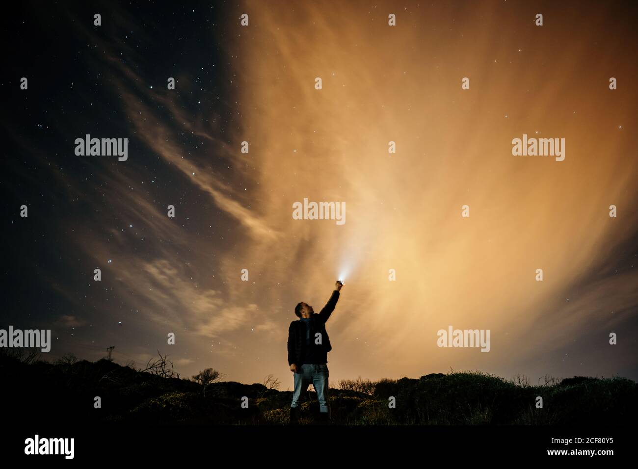 man standing under starry night Stock Photo - Alamy