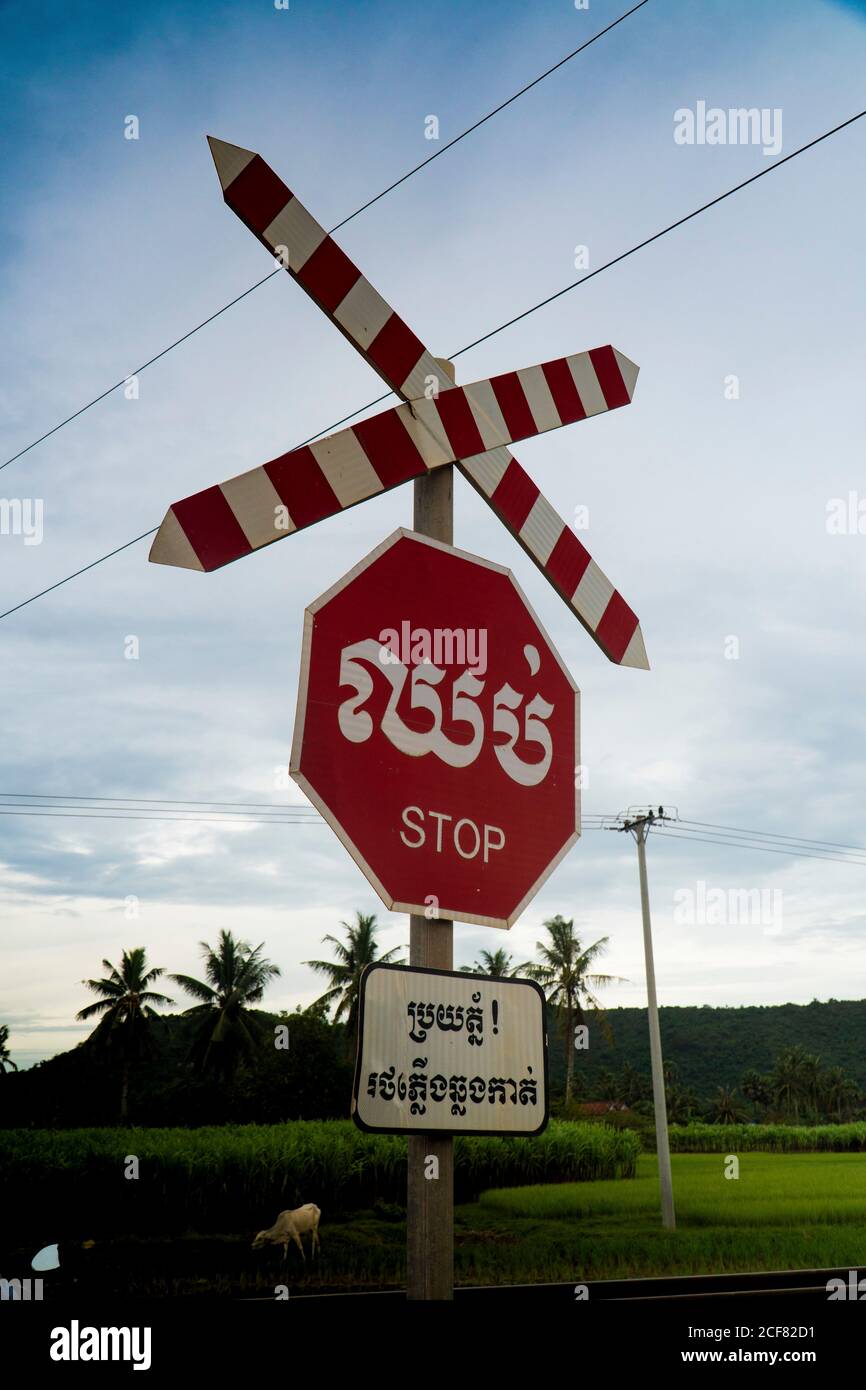 Red road sign saying stop in different languages on highway crossing ...