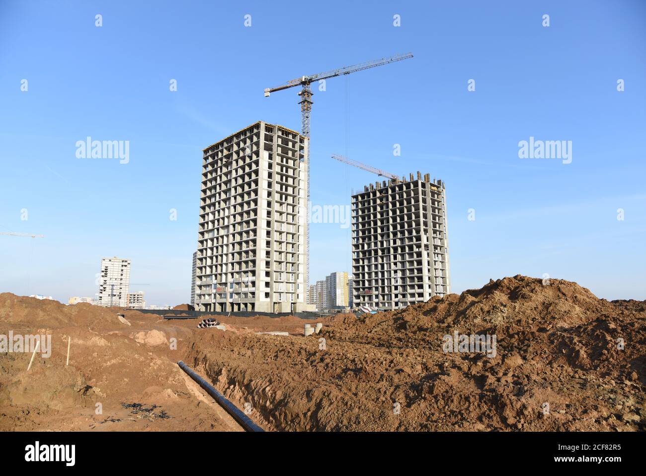 Tower cranes constructing a new residential build. Pouring concrete ...