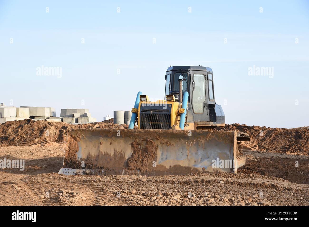 Bulldozer during of large construction jobs at building site. Crawler ...