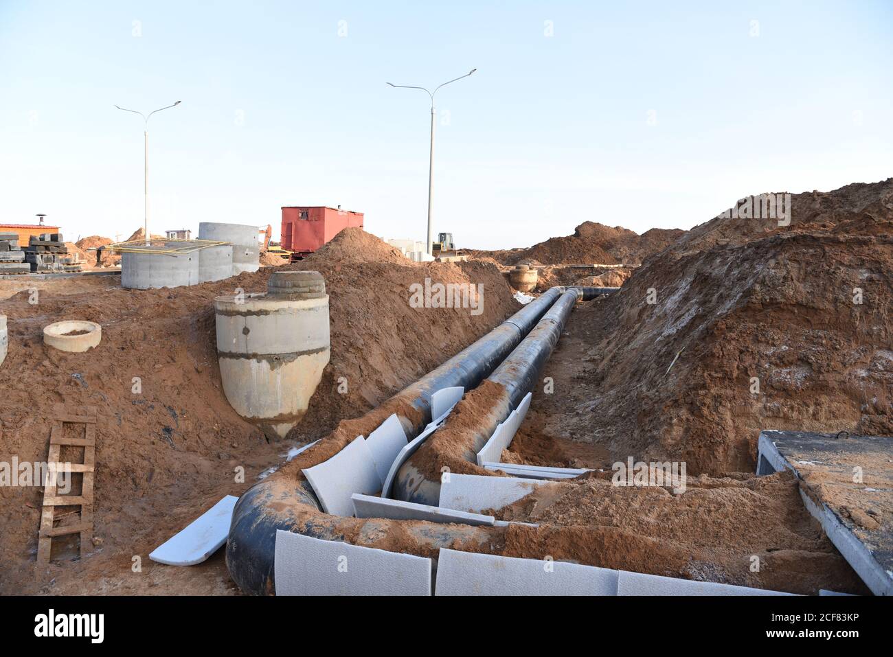 Installation of concrete sewer wells in the ground at the construction ...