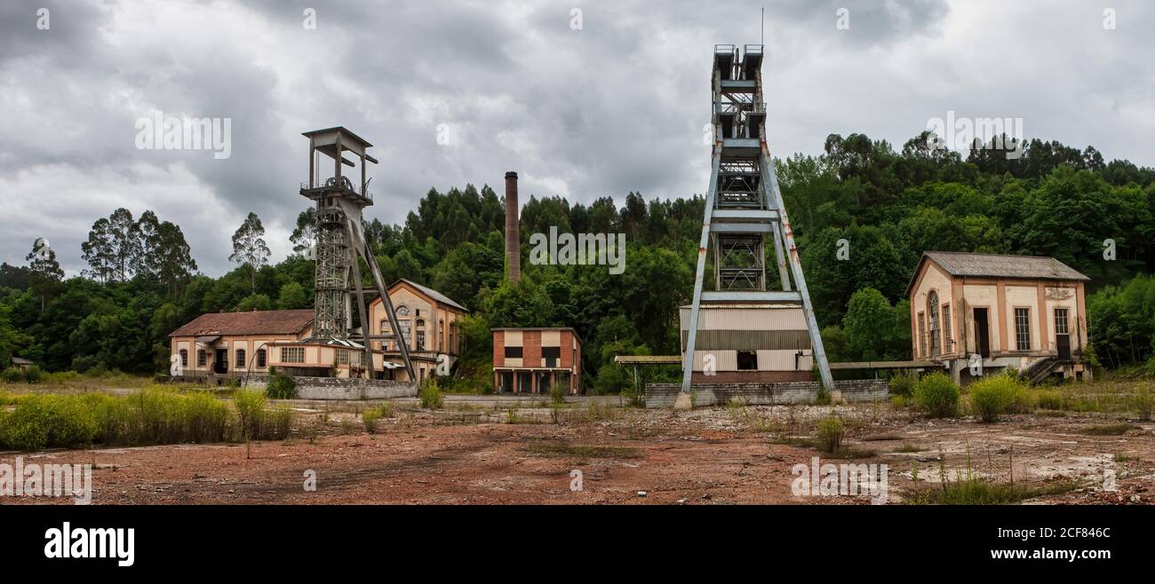 Empty yard with old abandoned buildings and mine mechanisms locating ...