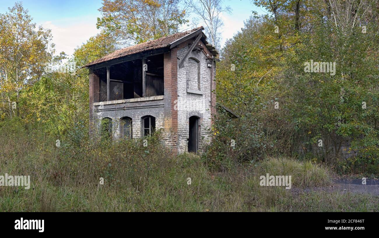Shabby ruined abandoned two story brick house with no door and broken ...
