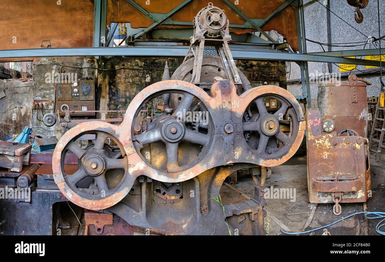Old used rusty mechanism made of steel discs of various diameters ...