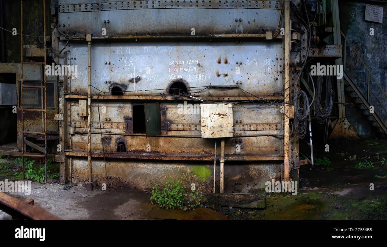 Shabby old ownerless high metal structure with rust layer painted in ...