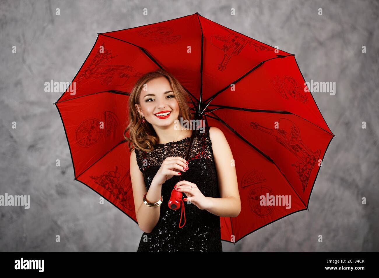 Portrait of a beautiful long-haired young girl in black evening dress ...