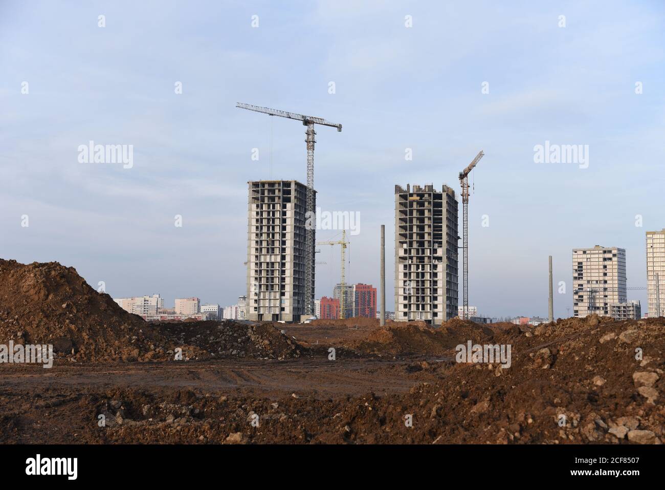 Tower cranes constructing a new residential build. Pouring concrete ...