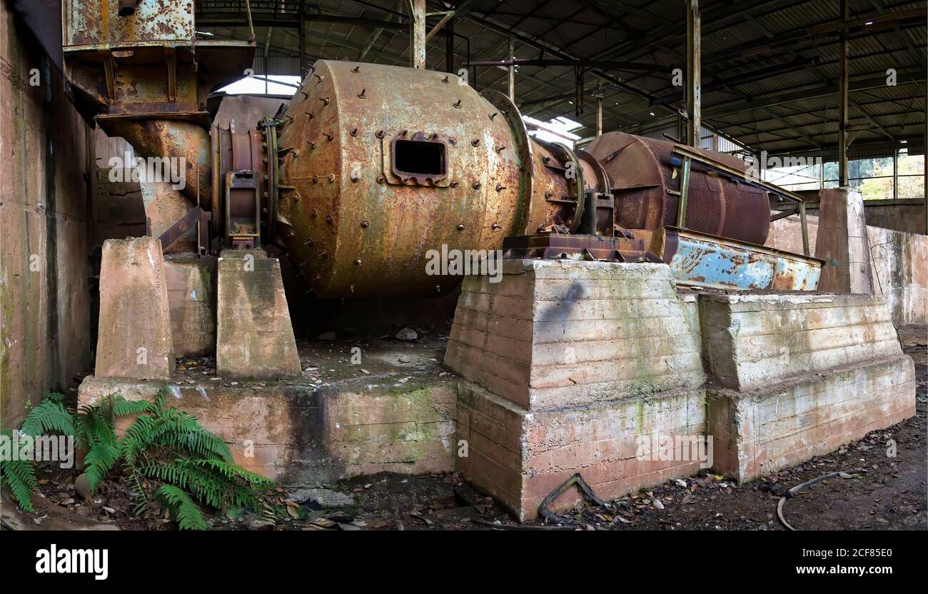 Rusty metal mechanism with pipes inside of abandoned industrial ...