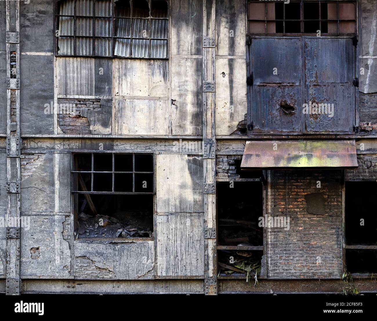 Exterior of old neglected industrial building with crumbling brick ...