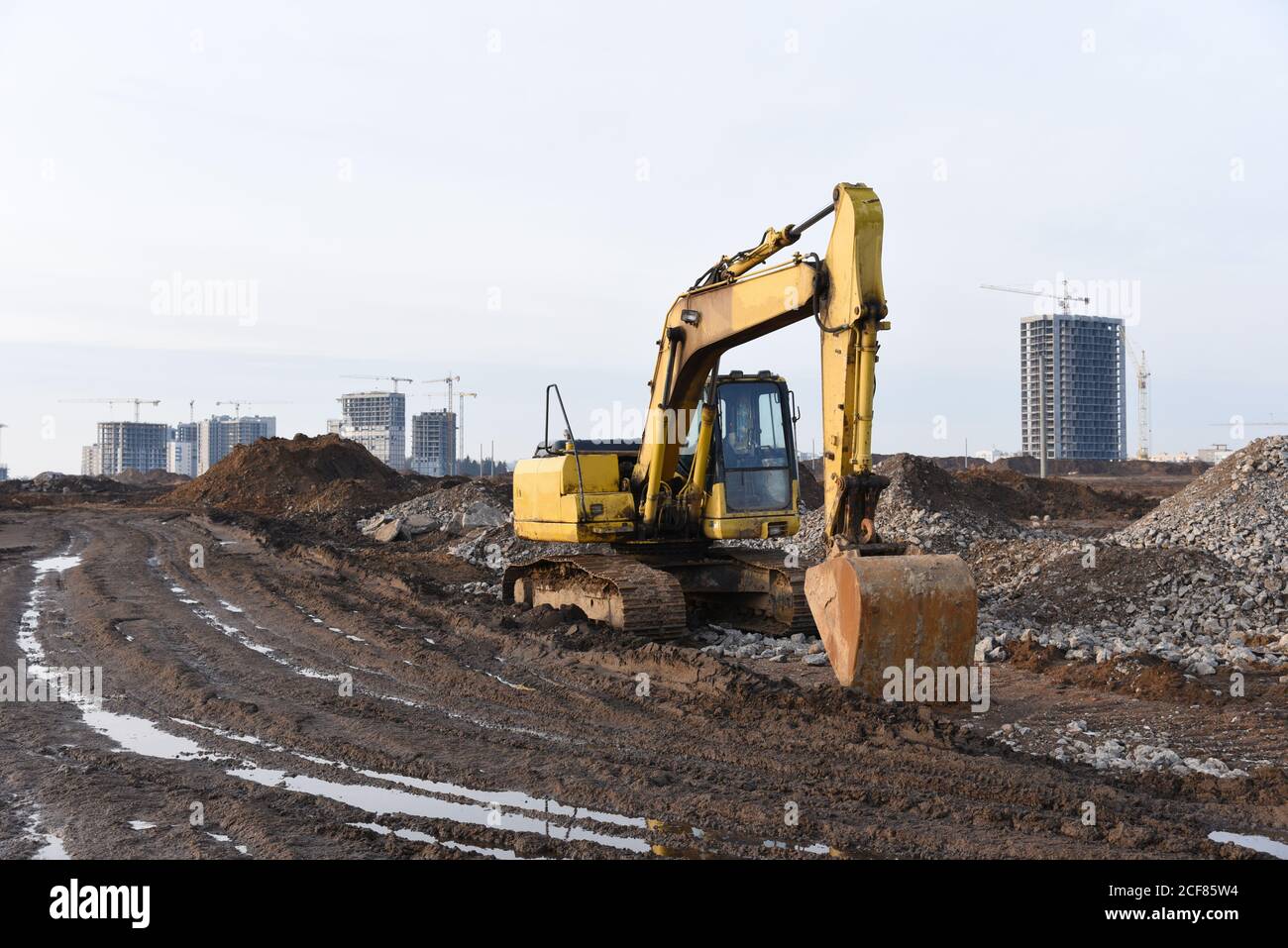Yellow excavator during groundwork on construction site. Hydraulic ...