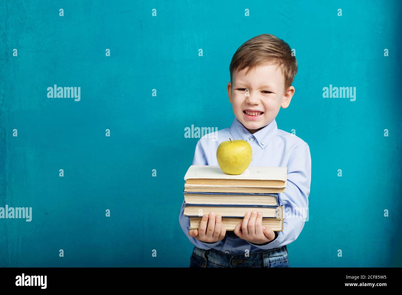 Book, school, kid. little student holding books. Cheerful smiling ...
