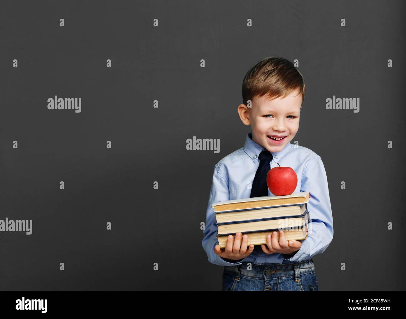 Book, school, kid. little student holding books. Cheerful smiling ...