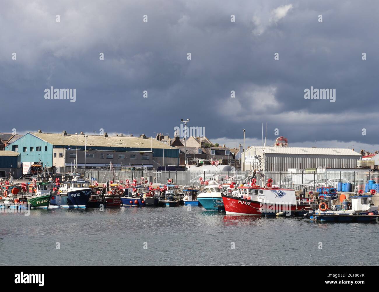 Fishing boats in harbour Stock Photo - Alamy