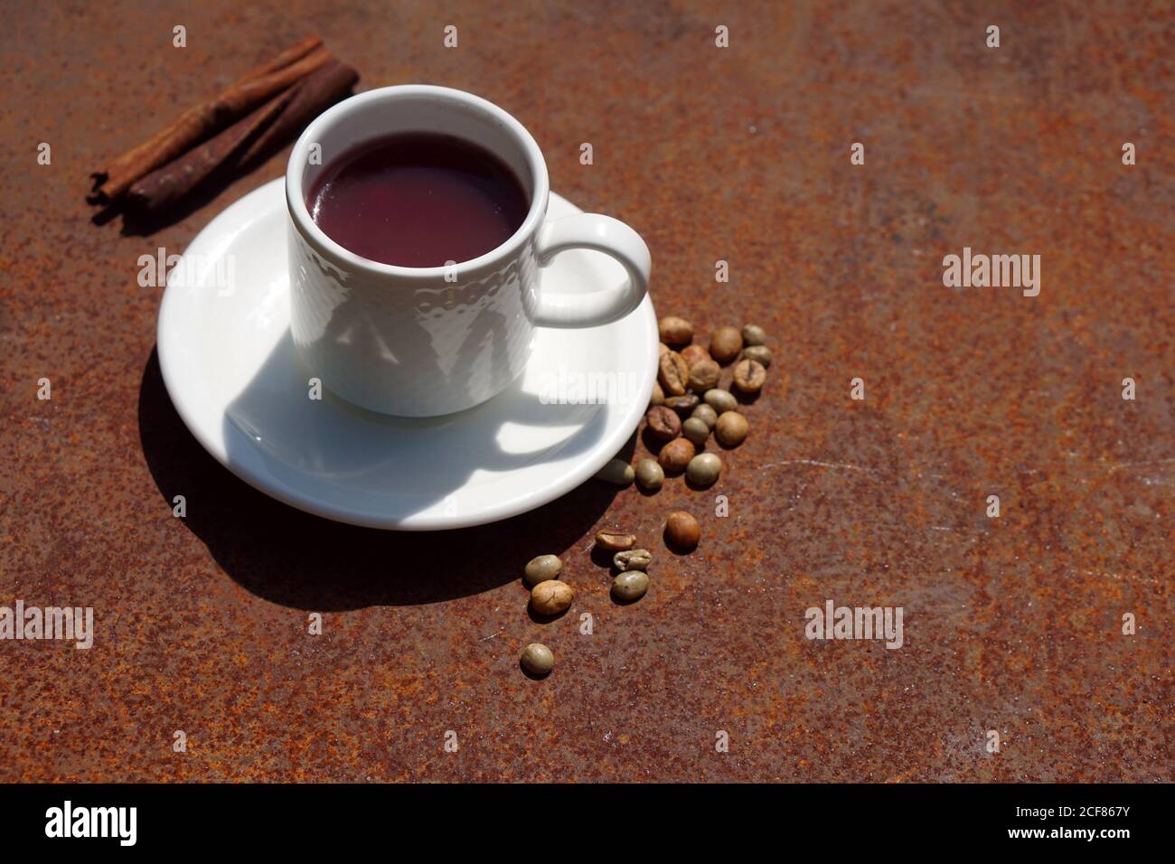 Flat lay Coffee composition with white cup of red coffee and beans of ...