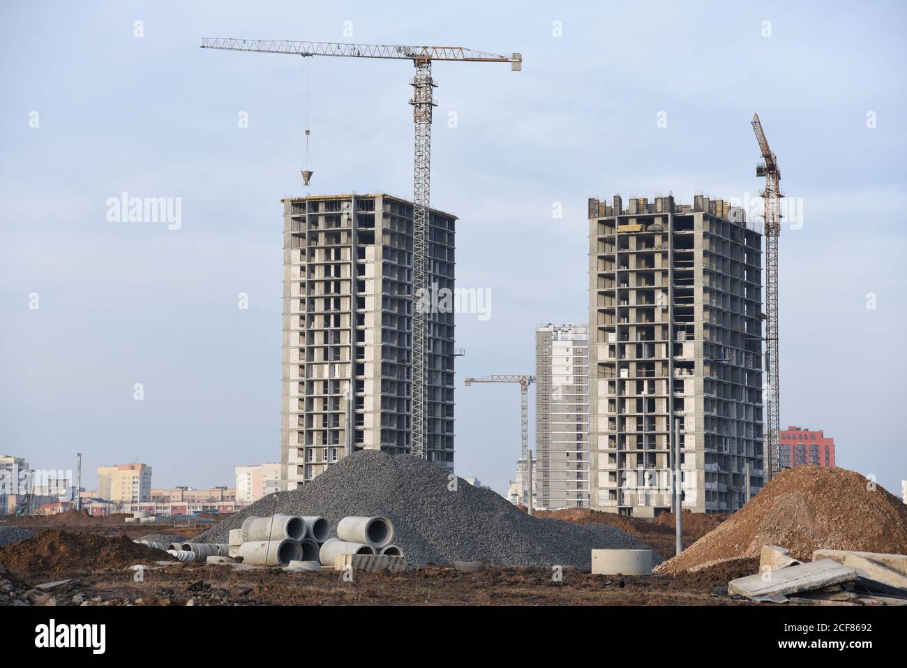 Tower cranes constructing a new residential build. Pouring concrete ...