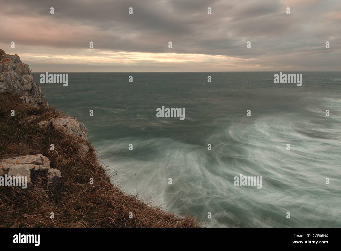 Powerful wave splashing at granite cliff Stock Photo - Alamy