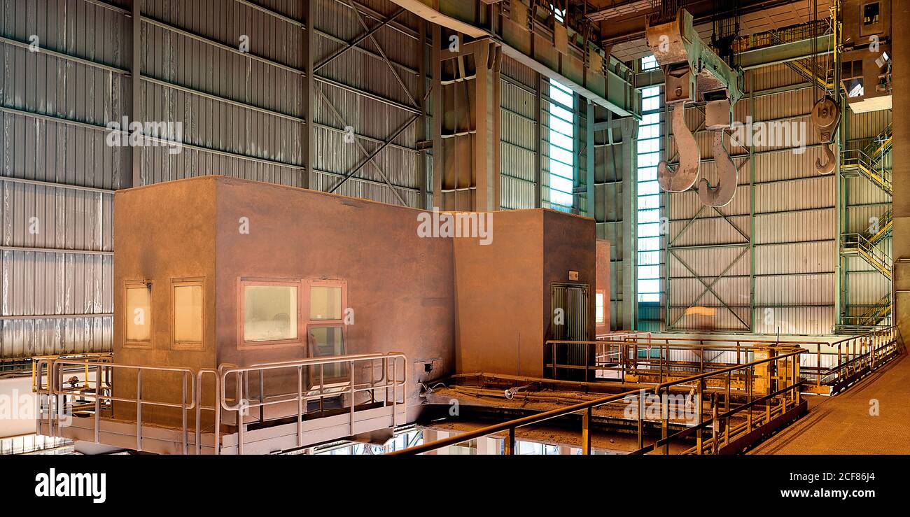 Interior of spacious workshop with large metal walls and construction ...