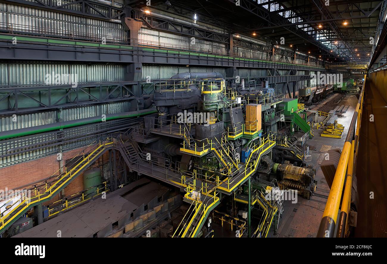 Interior of spacious industrial workshop with large metal construction ...
