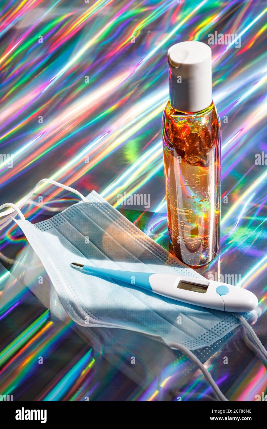 Glass of antiseptic liquid and forensic face respirator mask placed ...