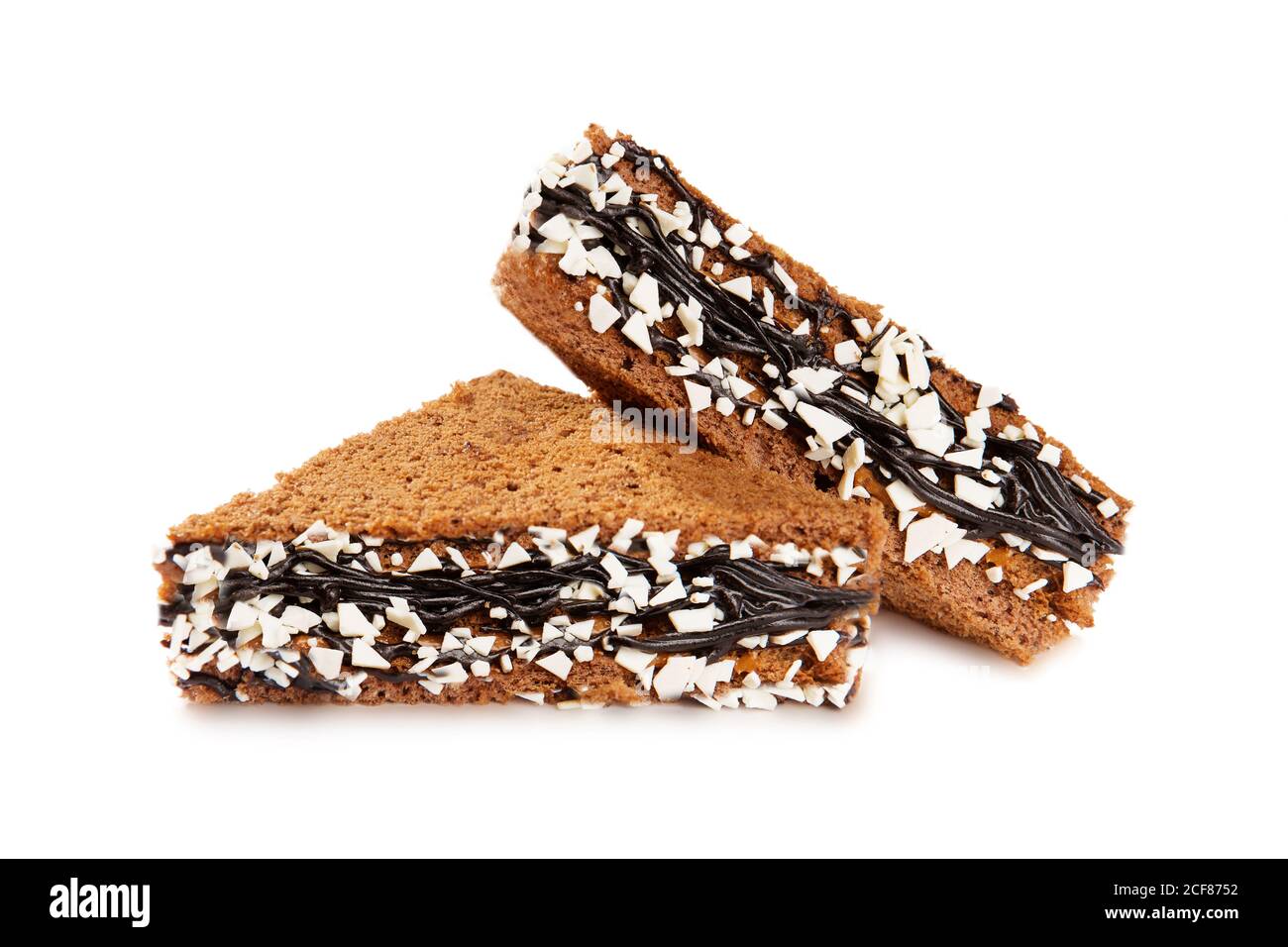 Cake decorated with chocolate cream icing and white chips isolated on ...