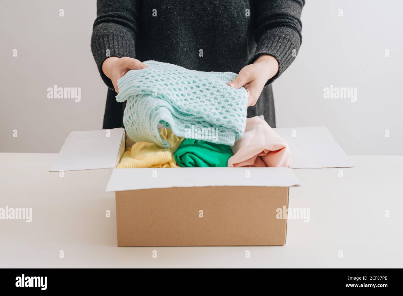 Donation Concept. Woman holding a Donate Box with full of Clothes Stock ...