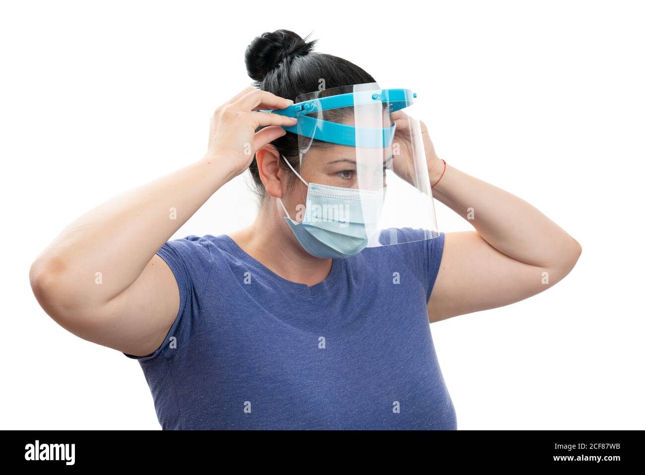 Female model arranging transparent face shield wearing medical or ...