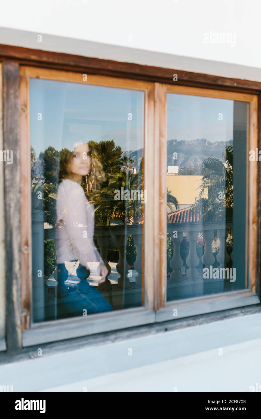 Old lady looking through window hi-res stock photography and images - Alamy