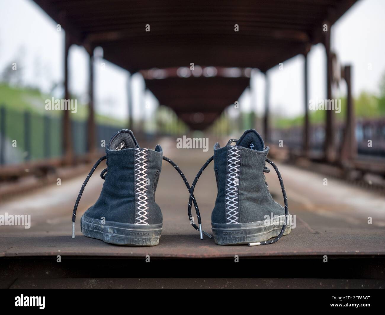 Pair of empty boots standing in a railway station Stock Photo - Alamy