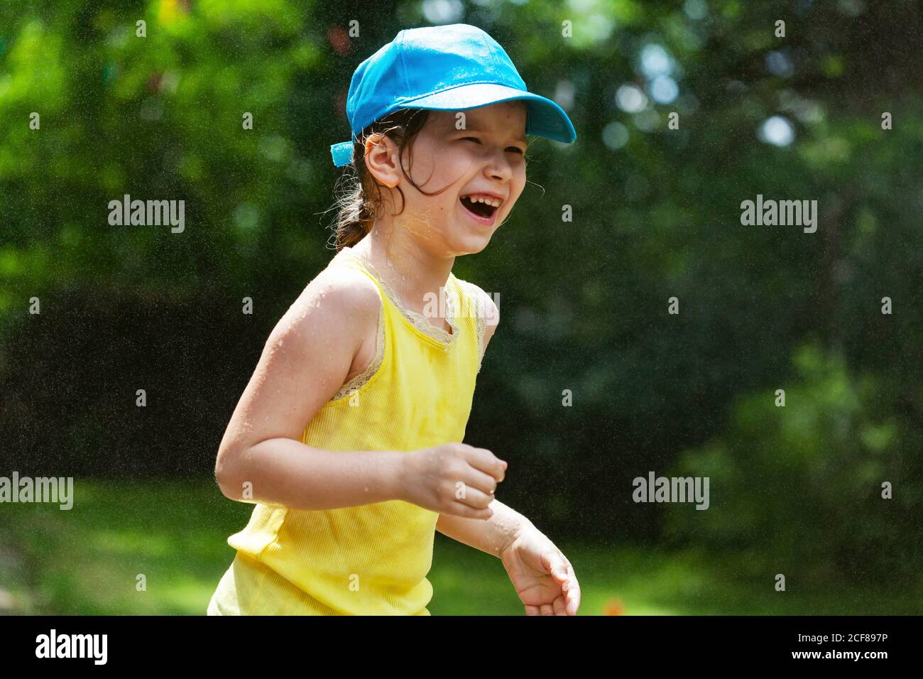 School child playing in the water spray hi-res stock photography and ...