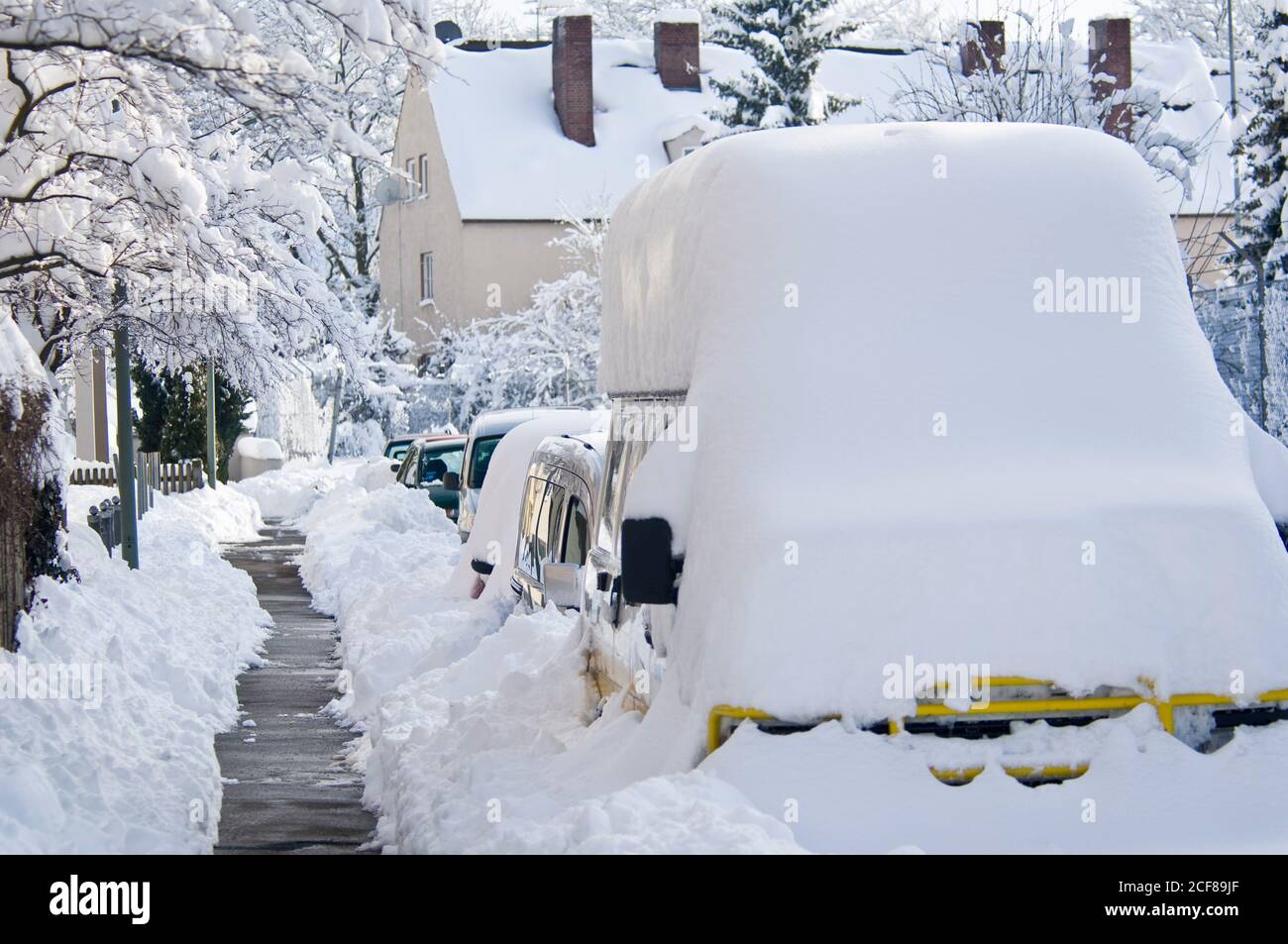 Snow-covered vehicles after heavy snowfall in urban area Stock Photo ...