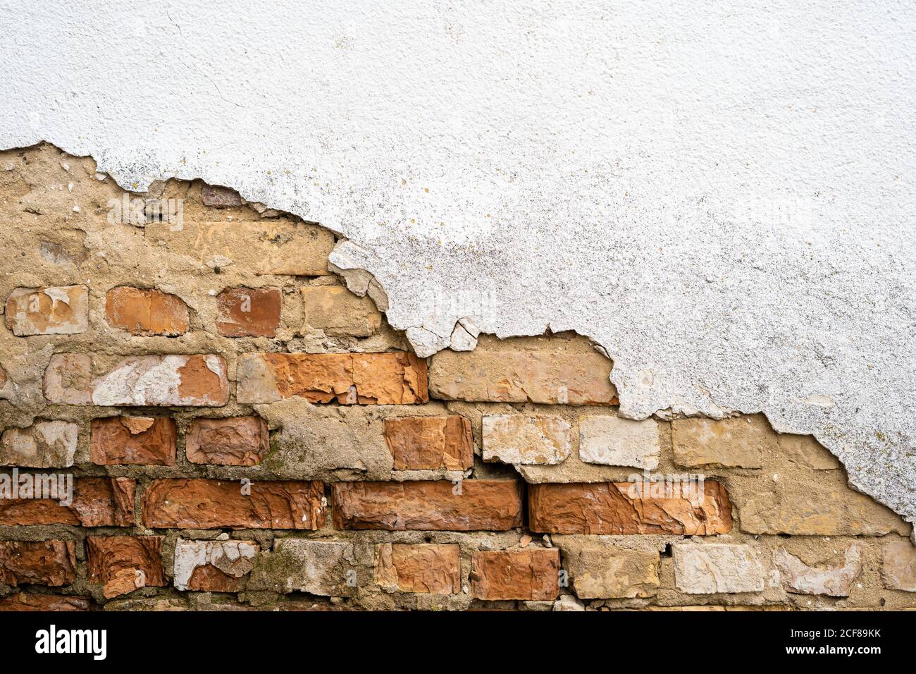 chipped plaster from the wall and visible brickwork Stock Photo - Alamy
